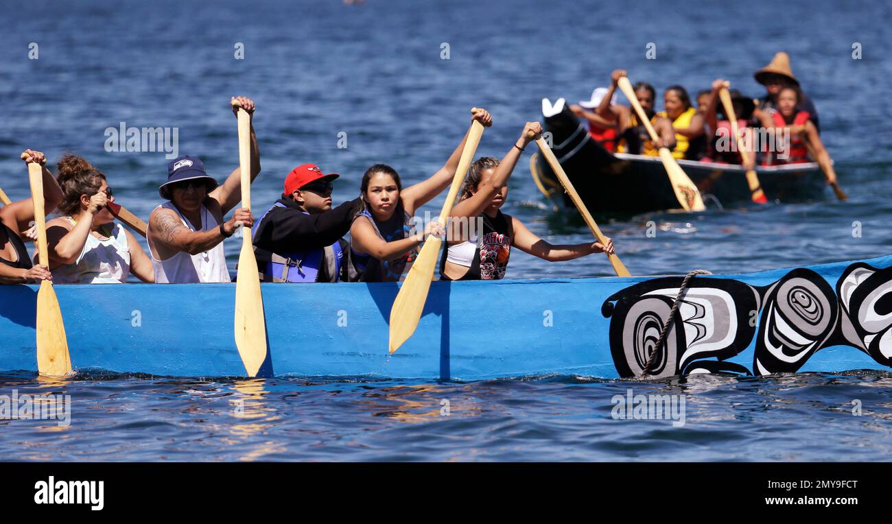 Tribal canoes head toward shore during an annual journey Wednesday ...