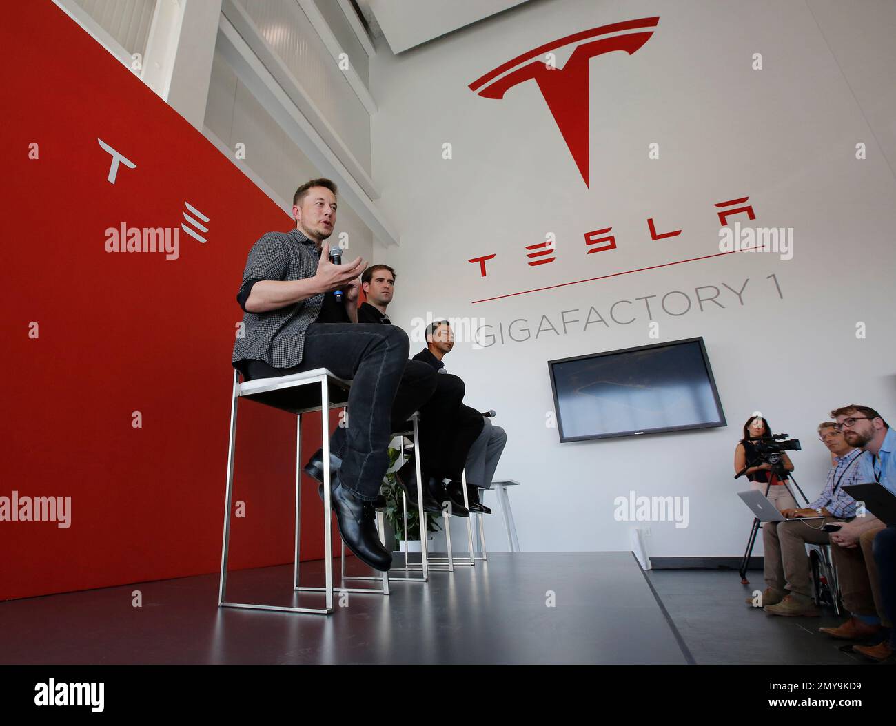 Elon Musk, CEO of Tesla Motors Inc., left, discusses the company's new ...