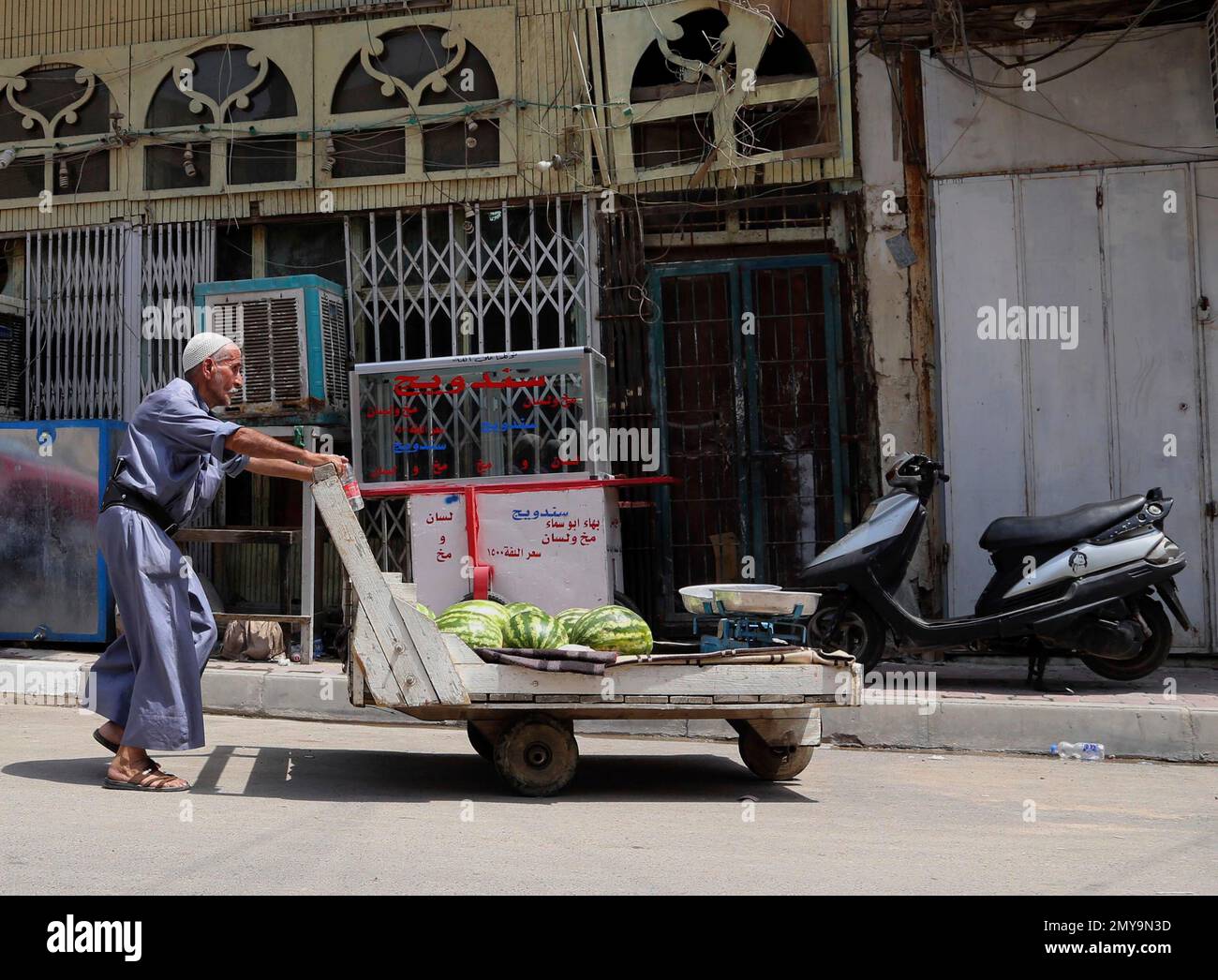 A street vendor sells watermelon at al-Rasheed street, the oldest ...