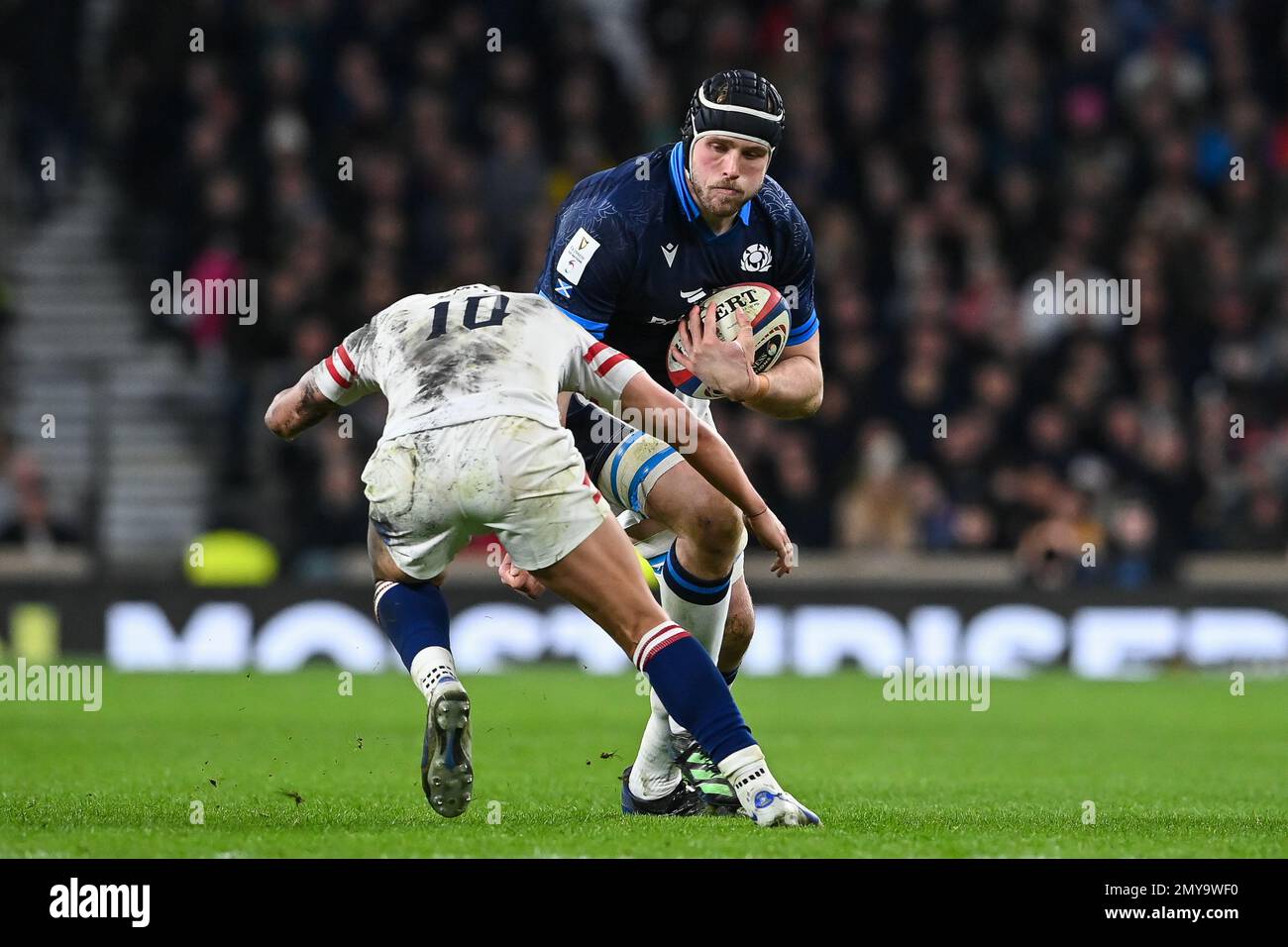 Jonny Gray of Scotland is tackled by Marcus Smith of England during the ...