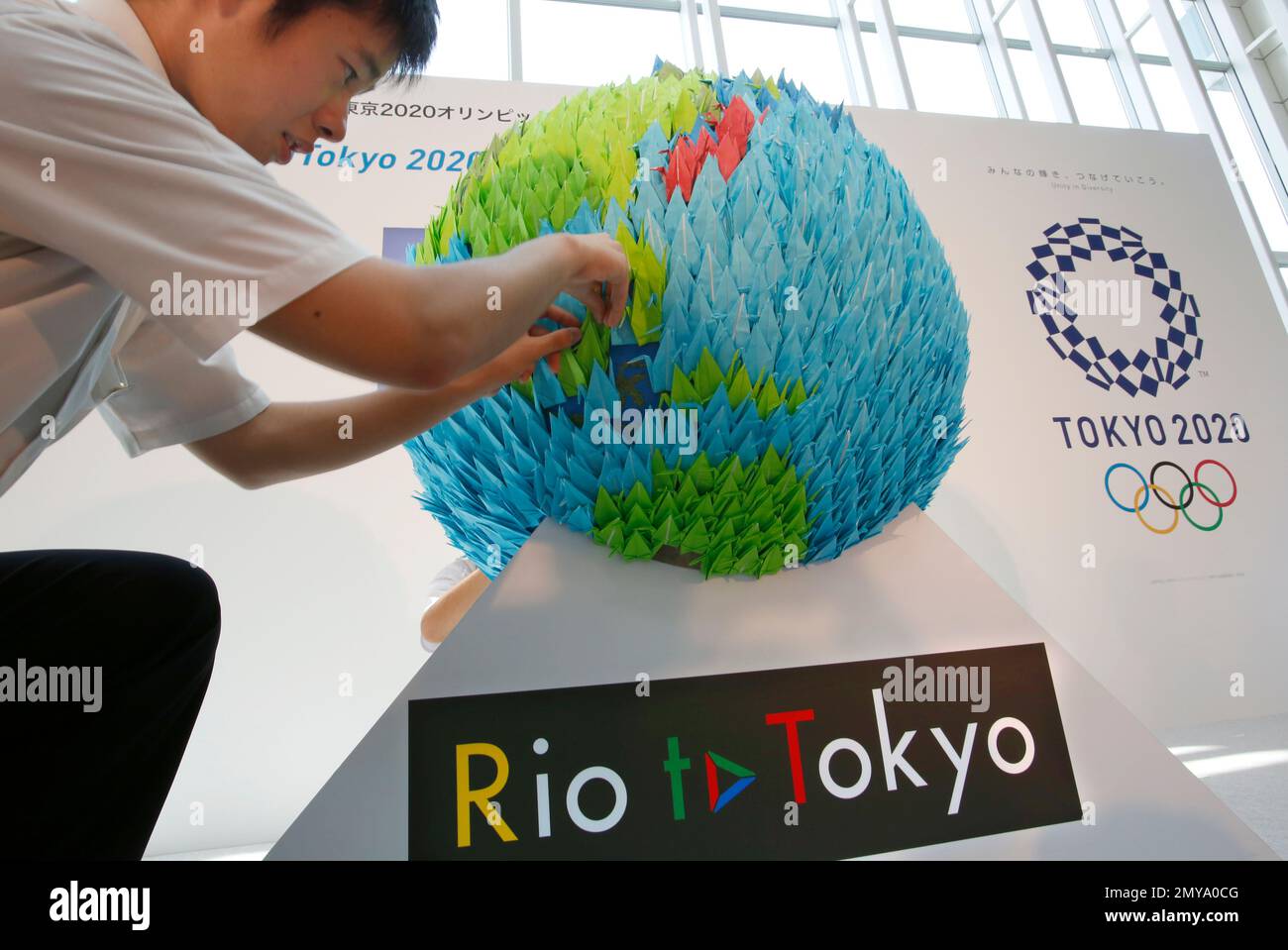A man adjusts a display for a 2020 Tokyo Olympic countdown event at ...