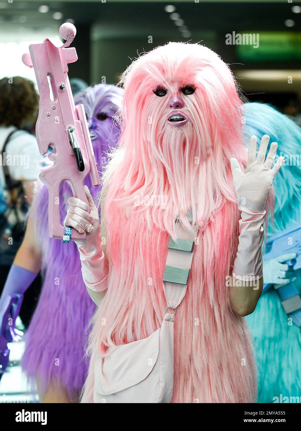 Ashley Bailey, dressed as one of "Chewie's Angels," waves to fans on ...