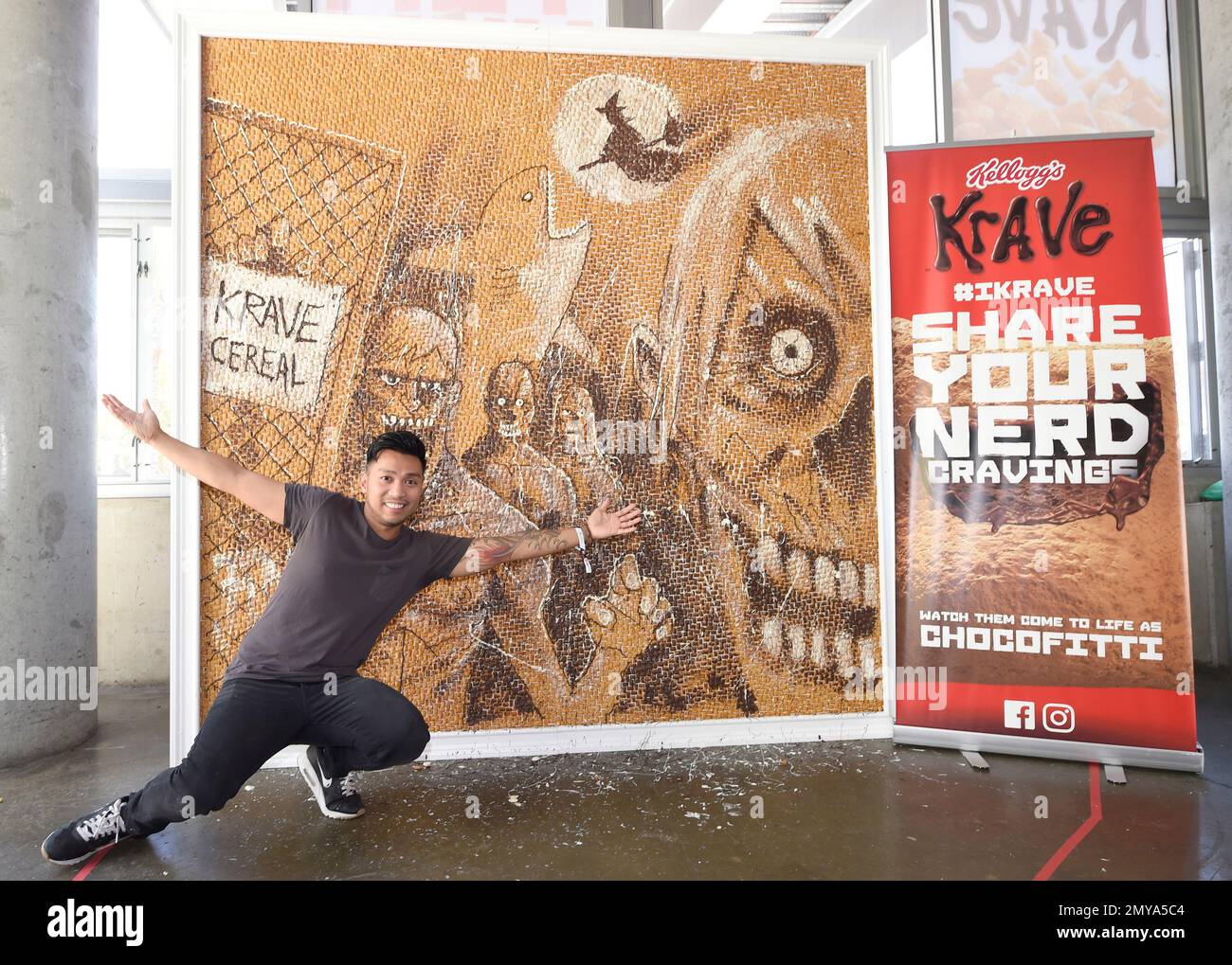 Illustrator Francis Manapul posed with hissecond Chocofitti wall ...