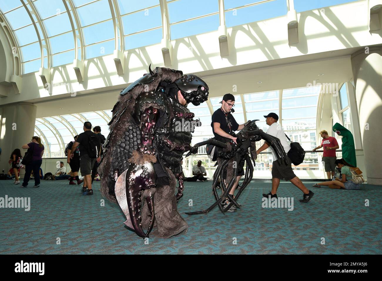 Costumed characters walk in the convention center on day two of Comic ...
