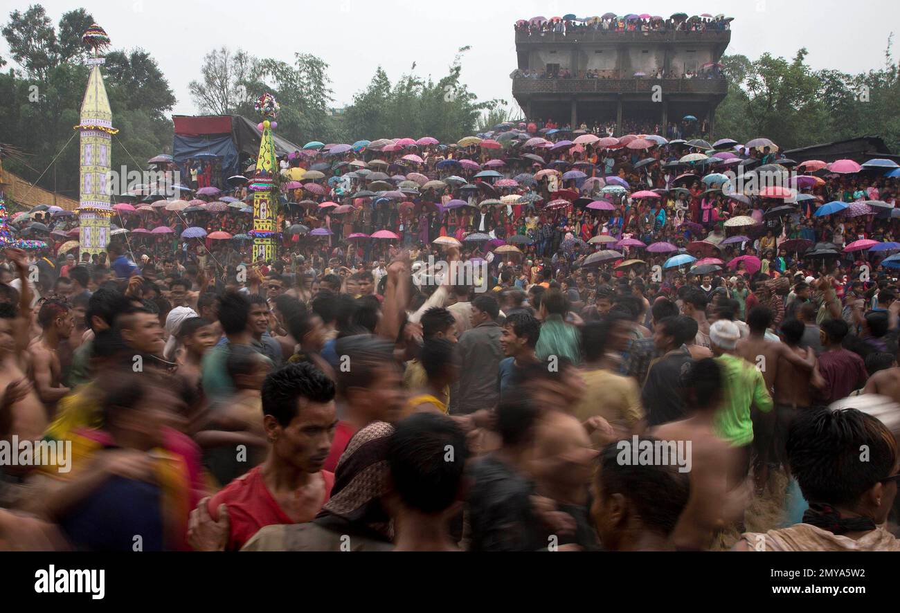 Pnar, also known as Jaintia tribesmen, dance in muddy waters during ...