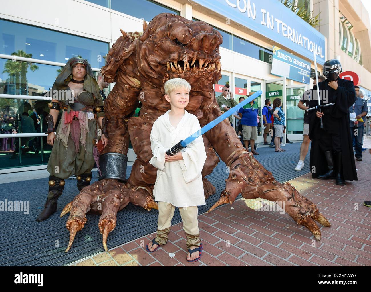Asher Huntsman, dressed as the character Luke Skywalker, poses with a ...