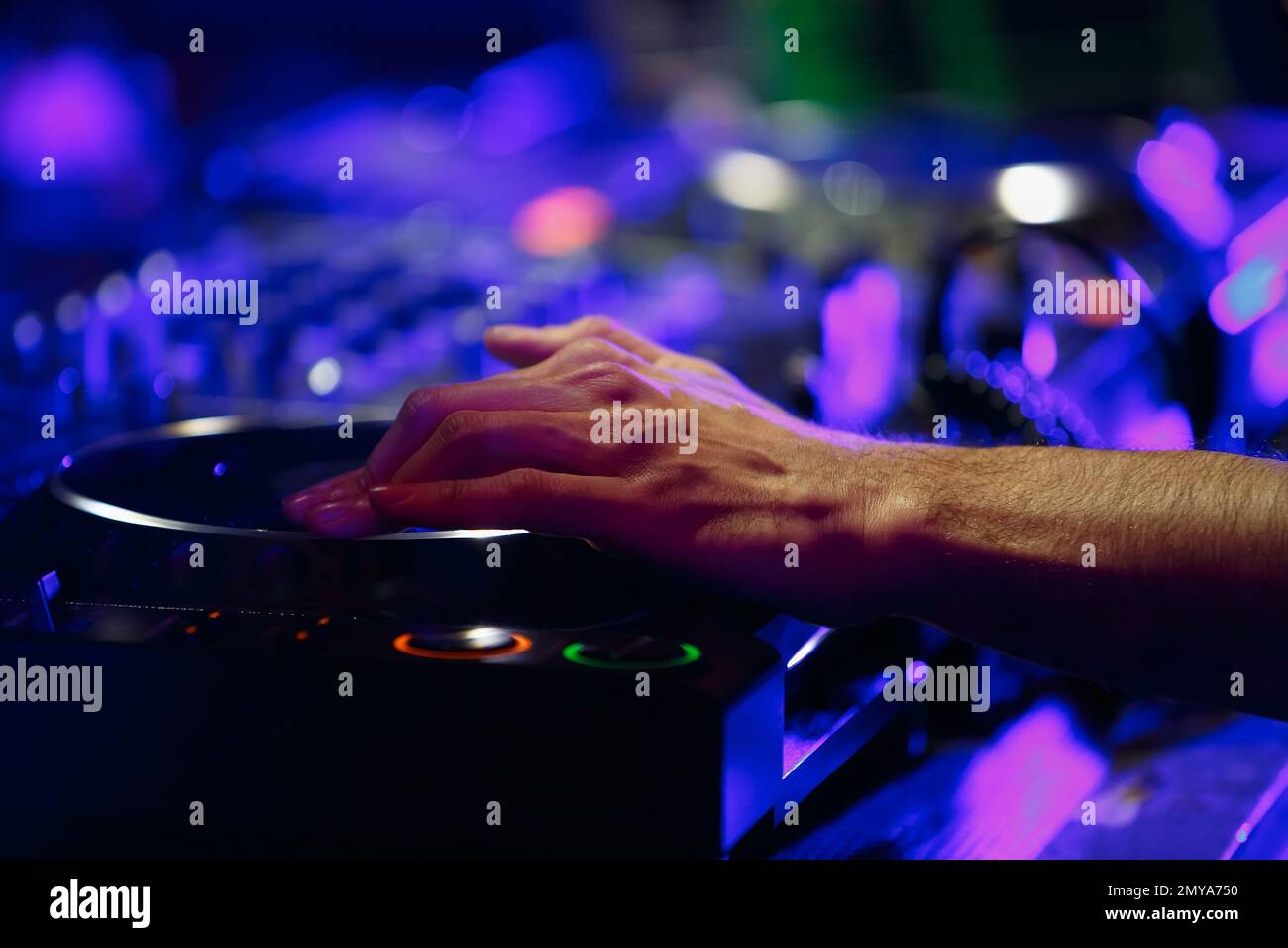 Club DJ plays music with professional cd turntable on party. Close up ...