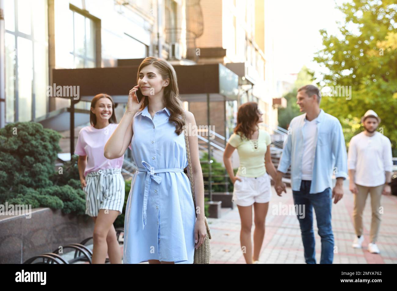 Different people walking on modern city street Stock Photo - Alamy
