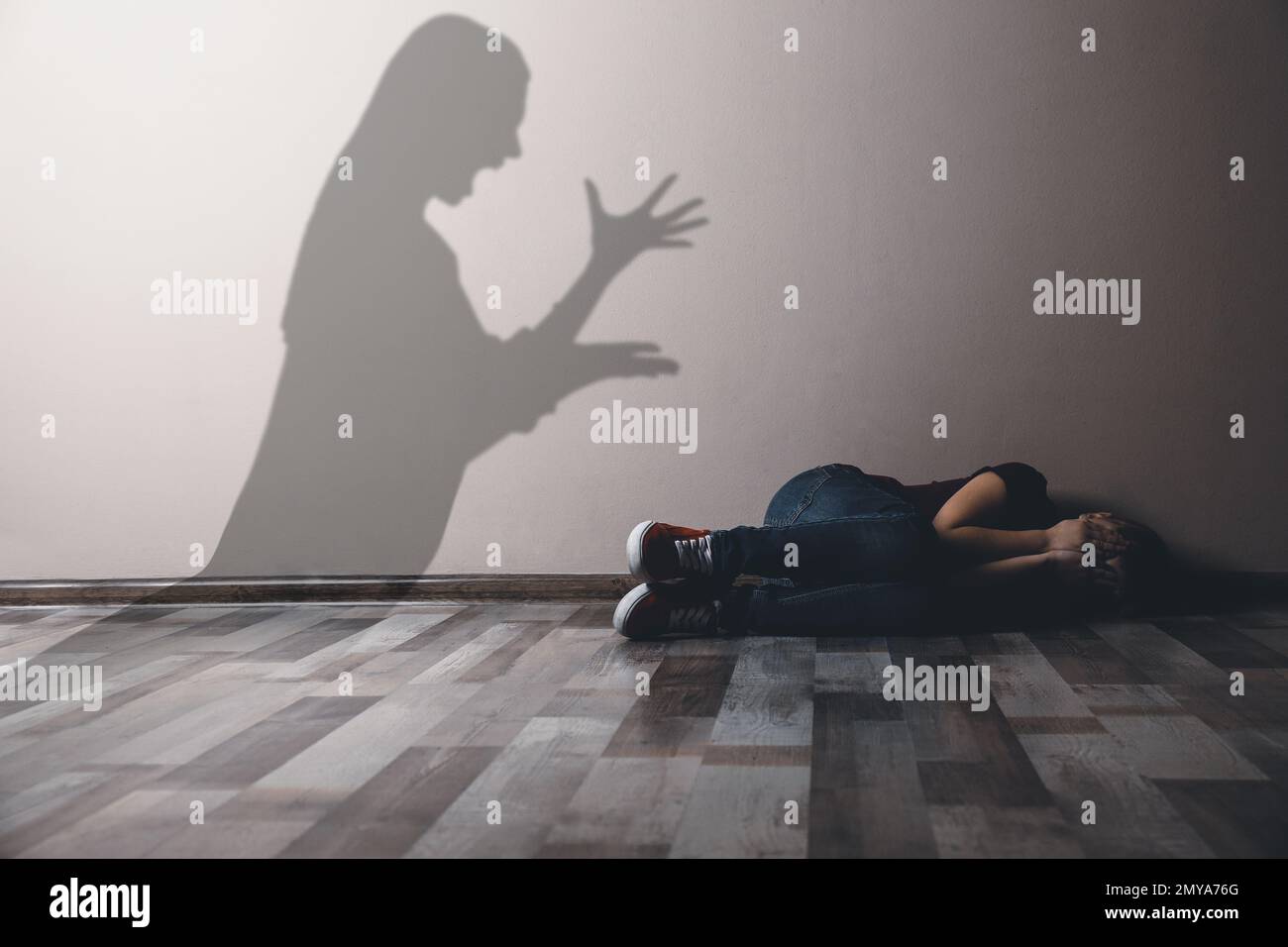 Child abuse. Mother yelling at her daughter. Shadow of woman on wall ...