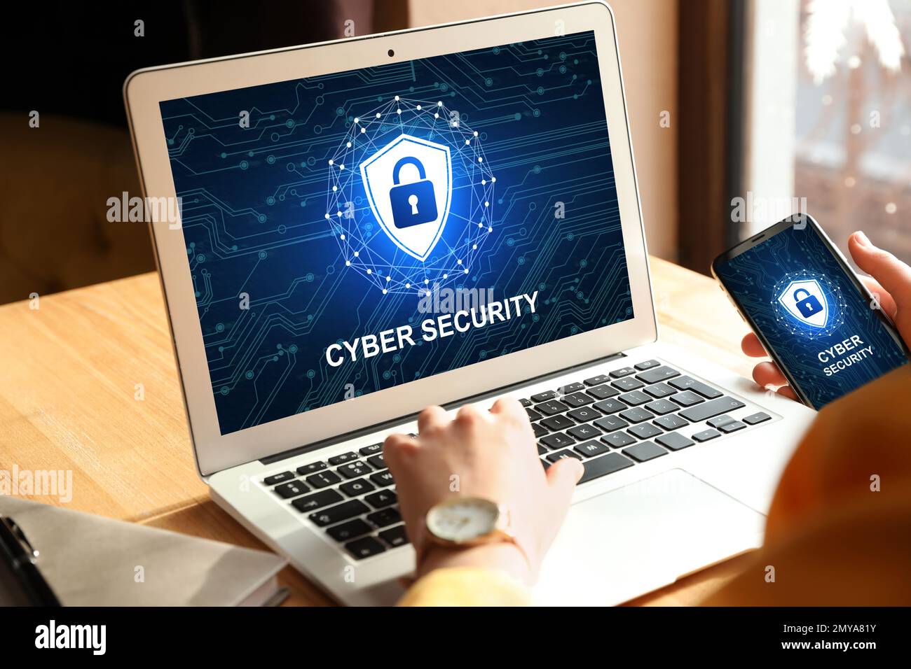 Cyber security concept. Woman using application on laptop and phone ...