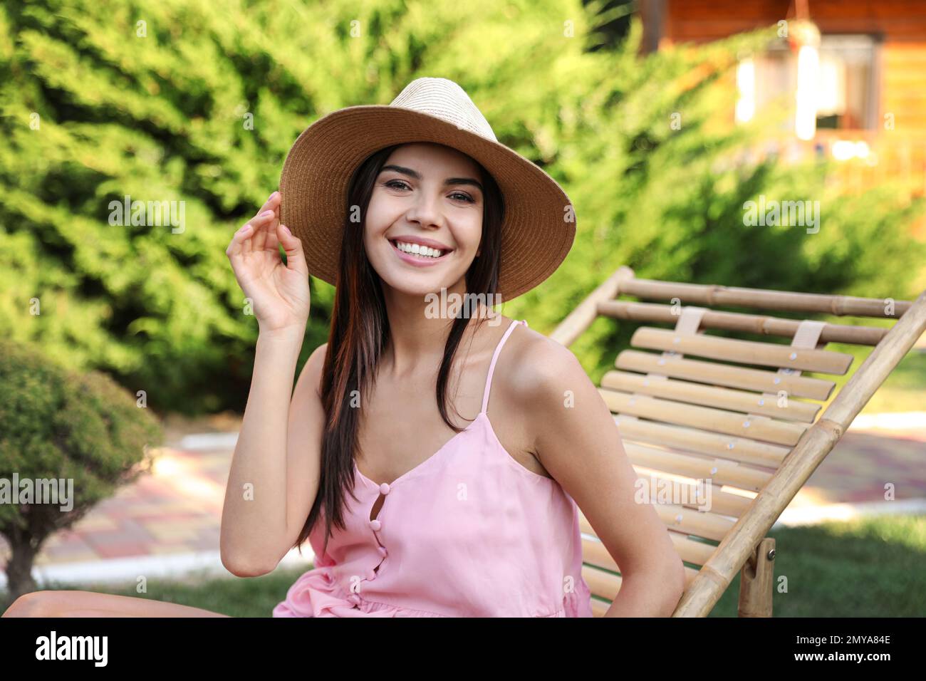 Young woman resting in deck chair outdoors Stock Photo - Alamy