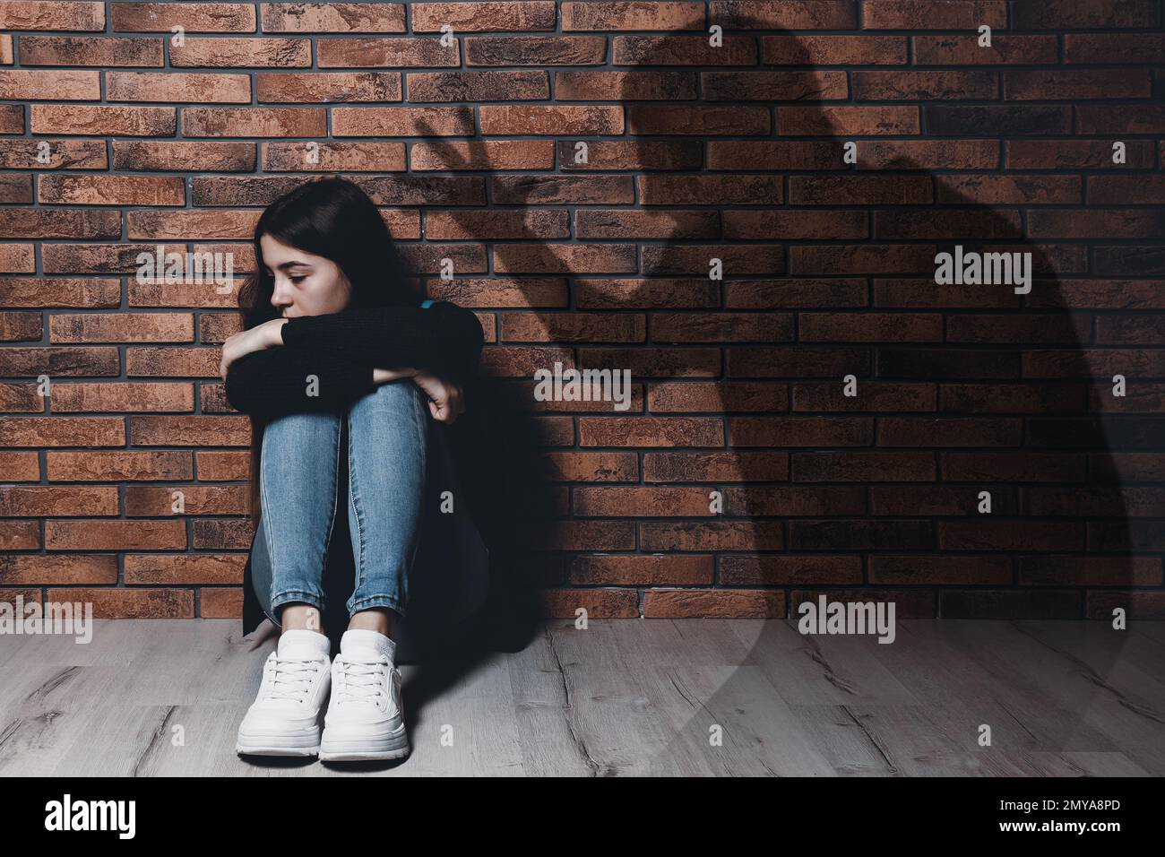 Child abuse. Father yelling at his daughter. Shadow of man on brick ... Child abuse. Father yelling at his daughter. Shadow of man on brick ...