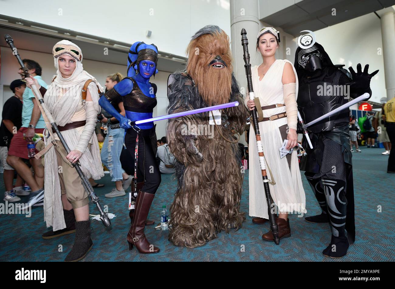 Costumed characters pose for photographers on day one of Comic-Con ...
