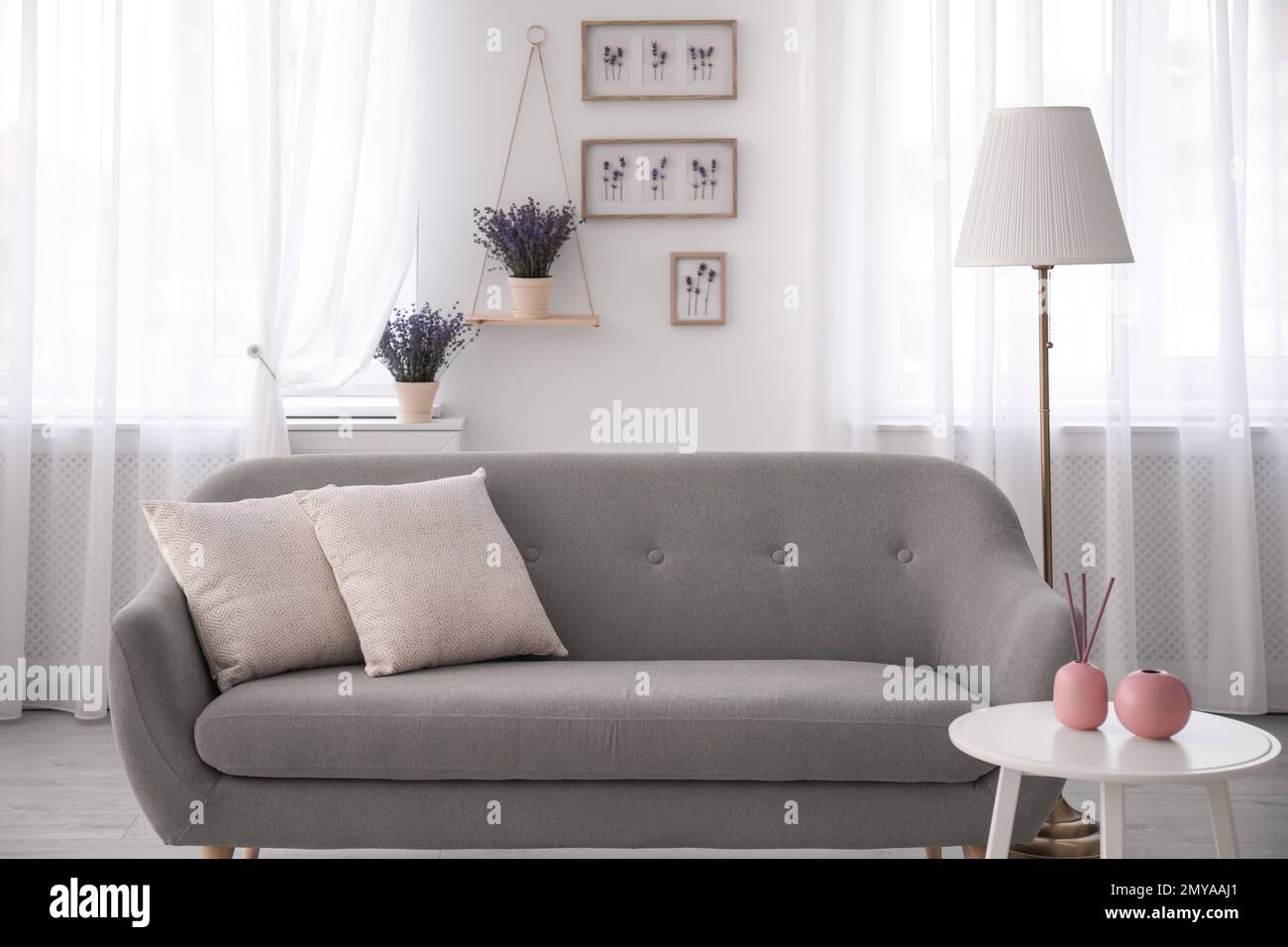 Stylish sofa in beautiful living room interior Stock Photo - Alamy