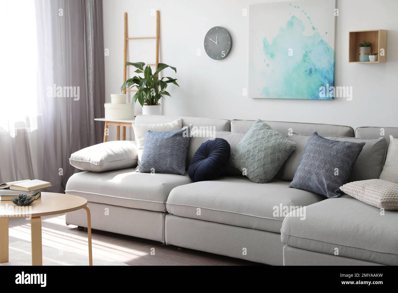 Elegant living room with comfortable sofa near window. Interior design ...