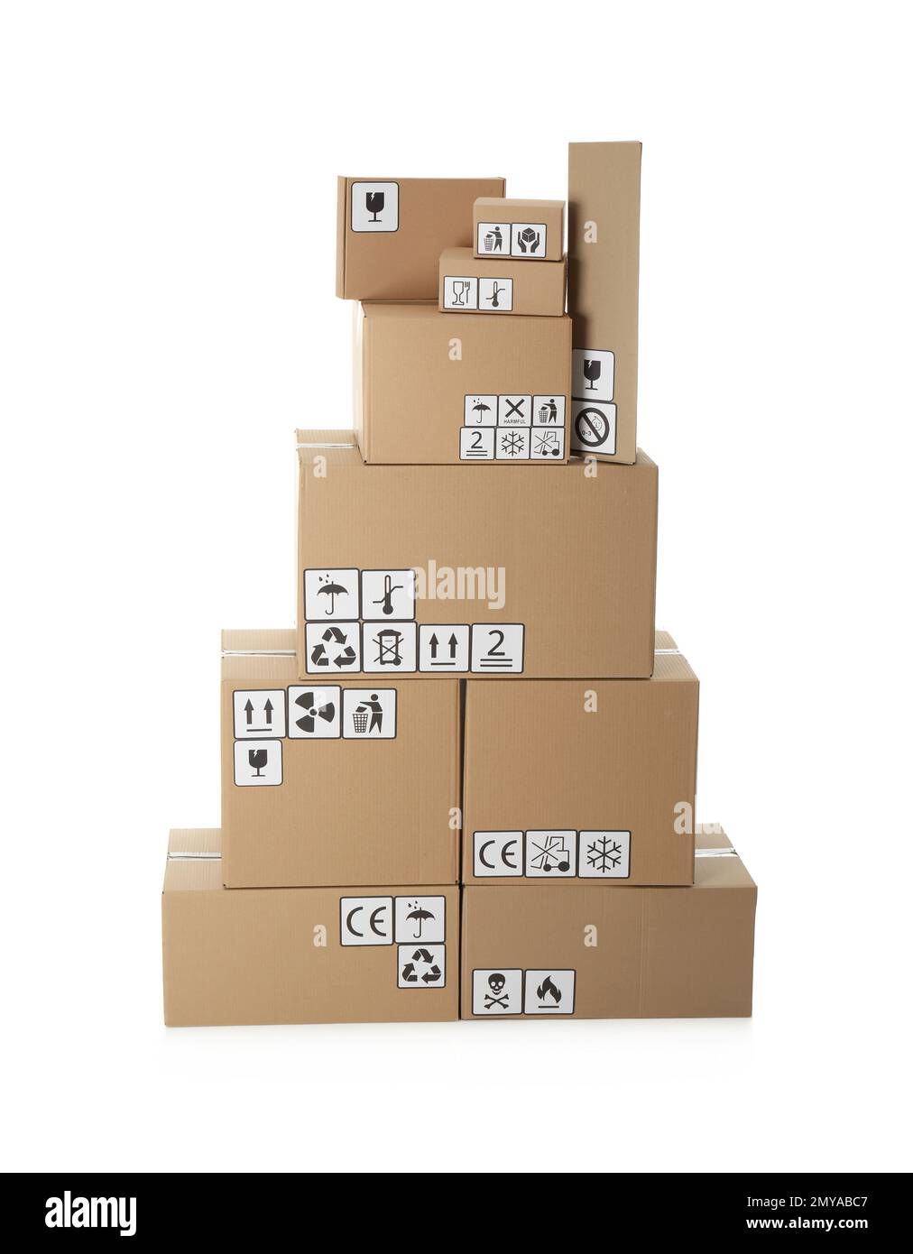 Stack of cardboard boxes with different packaging symbols on white ...