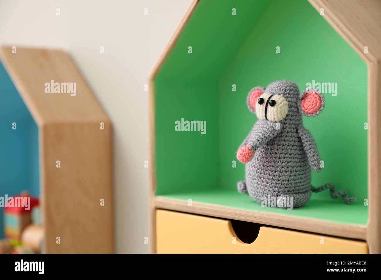 Knitted mouse on house shaped shelf indoors, closeup. Baby room ...