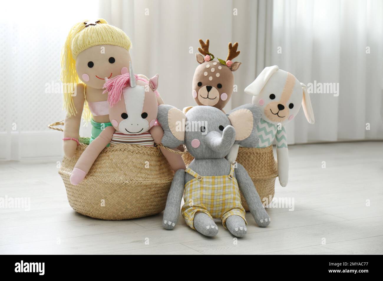 Funny stuffed toys in baskets on floor. Decor for children's room ...