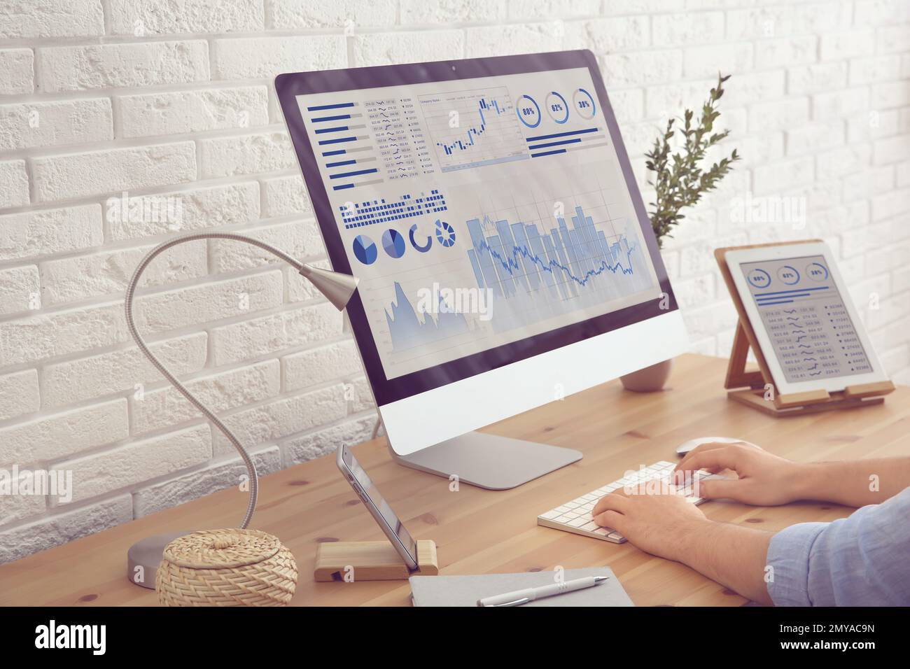 Young man using modern computer at table, closeup. Fintech concept ...