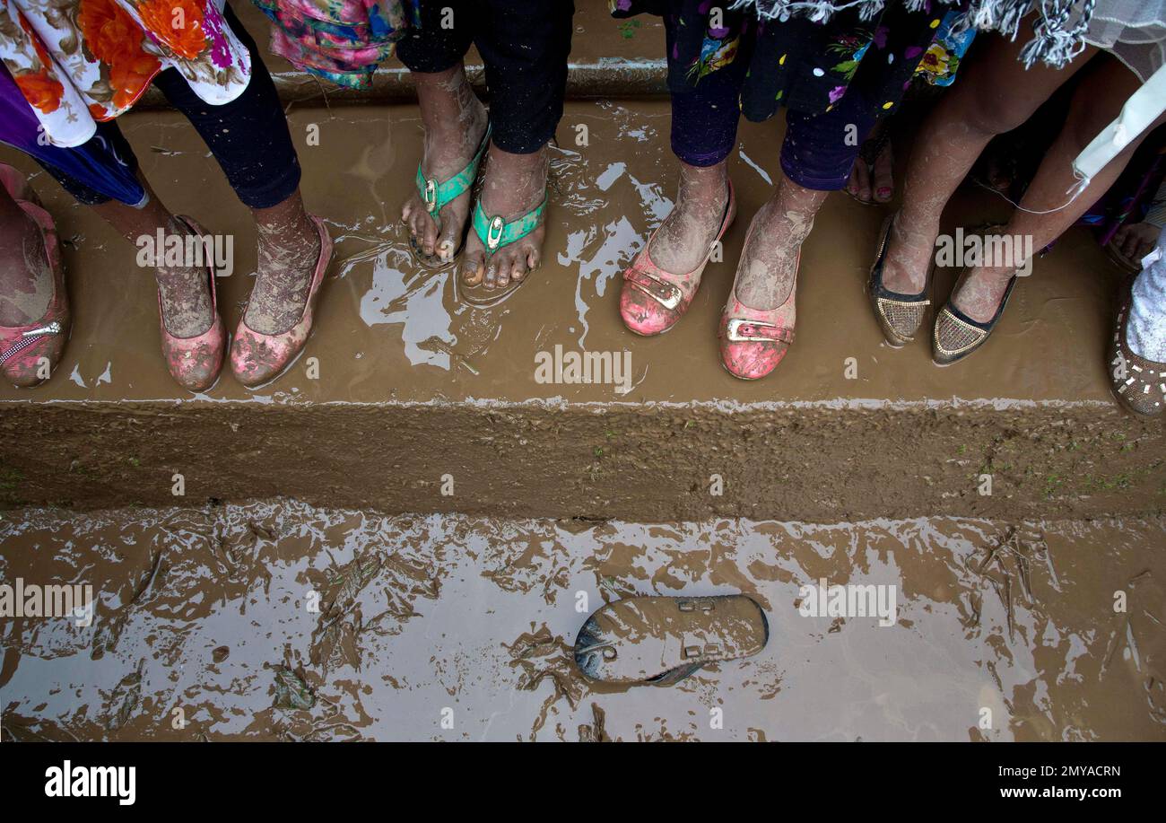 Indian girls stand with muddied feet as they watch Behdienkhlam ...