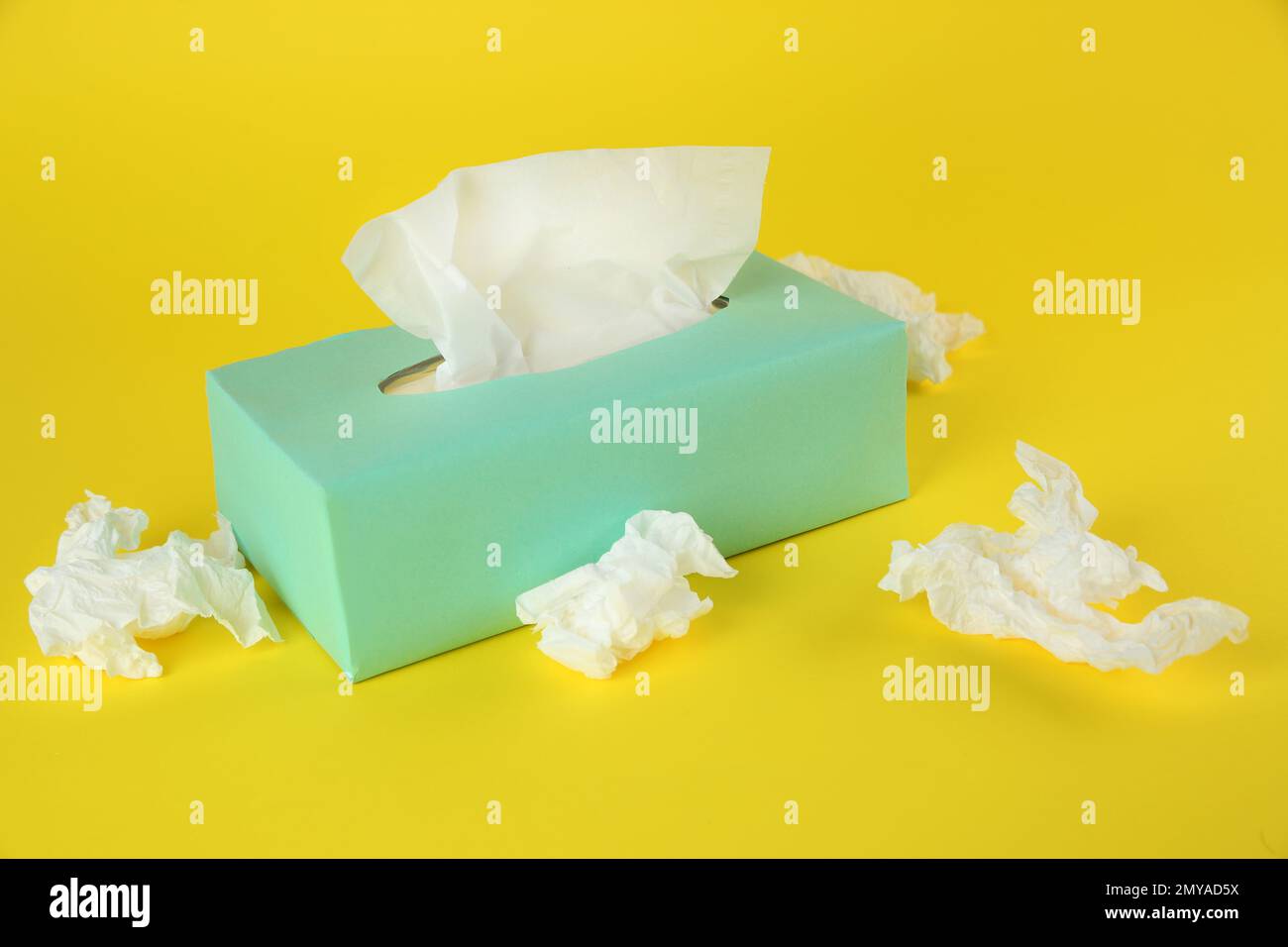 Used paper tissues and box on yellow background Stock Photo - Alamy