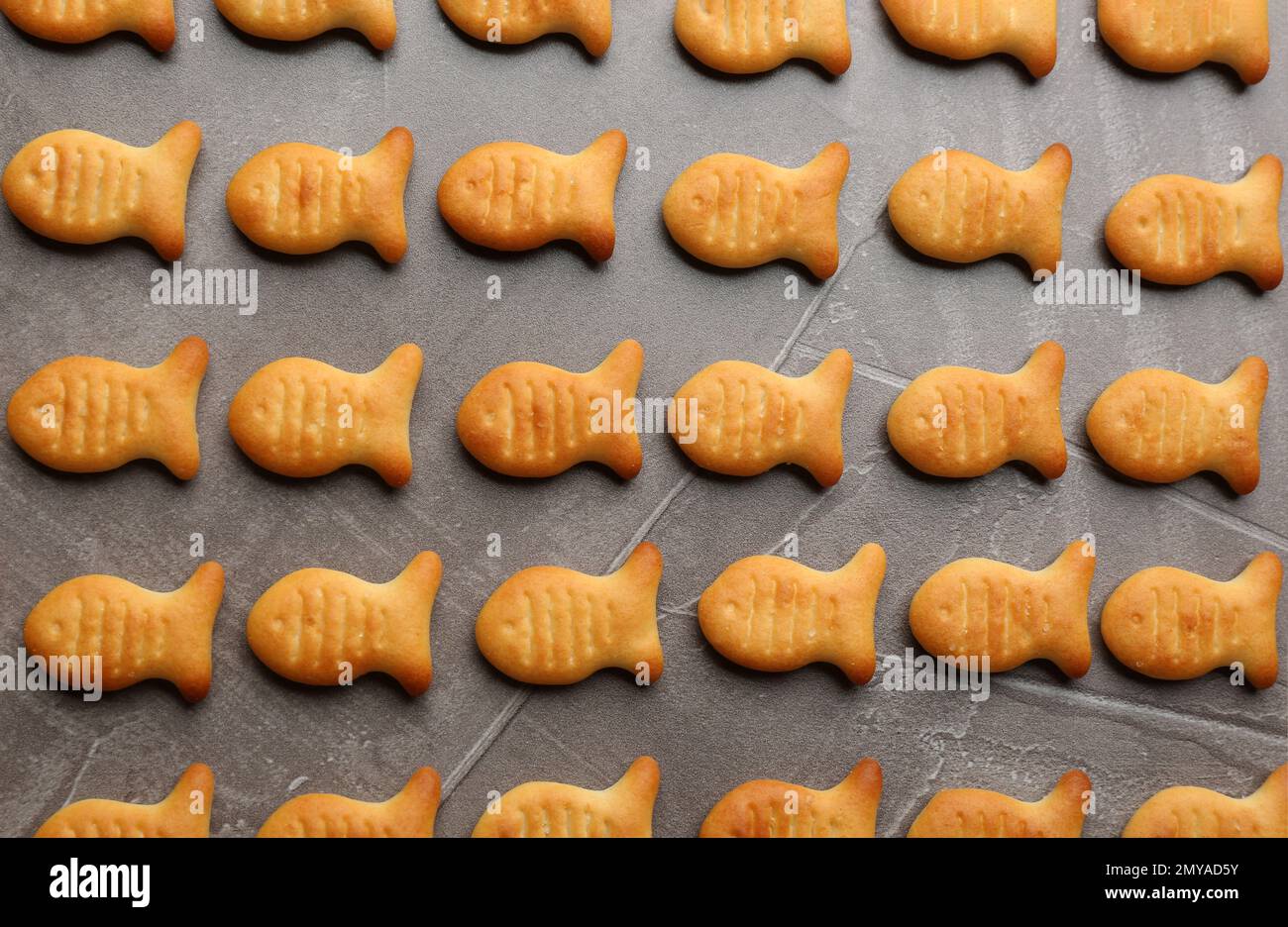 Delicious goldfish crackers on grey table, flat lay Stock Photo - Alamy