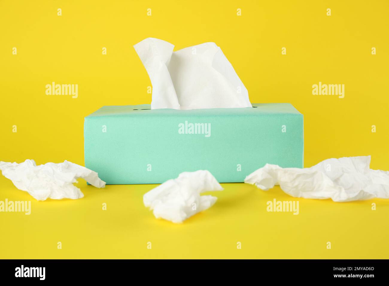 Used paper tissues and box on yellow background Stock Photo - Alamy