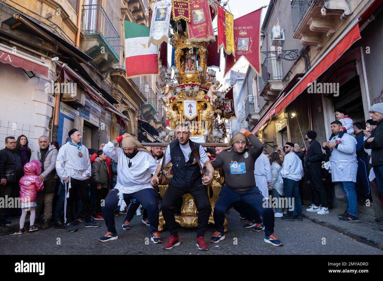 People seen carrying a traditional candelora on the streets of Catania ...