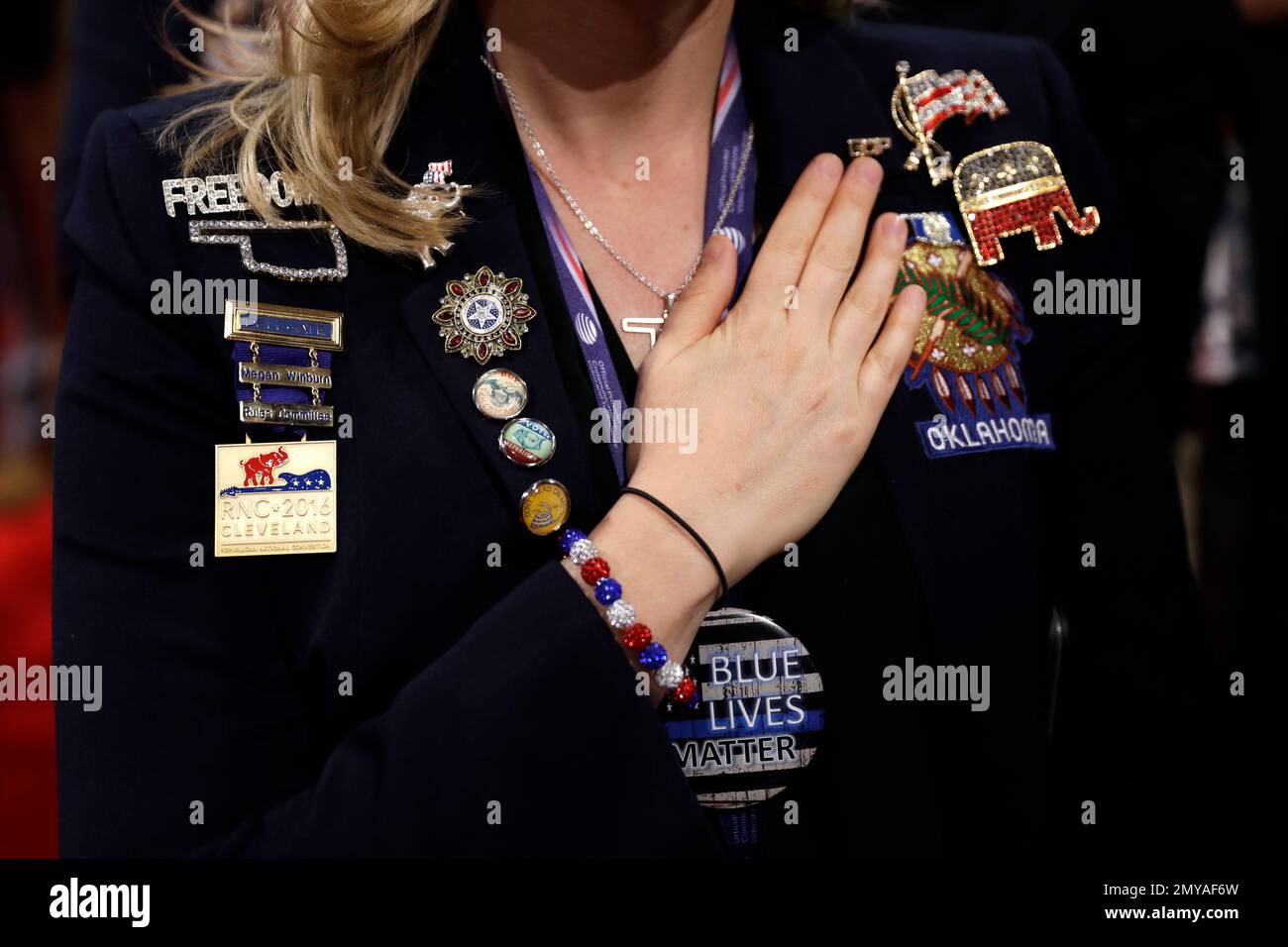 Oklahoma delegate Megan Windburn places her hand on her chest during ...