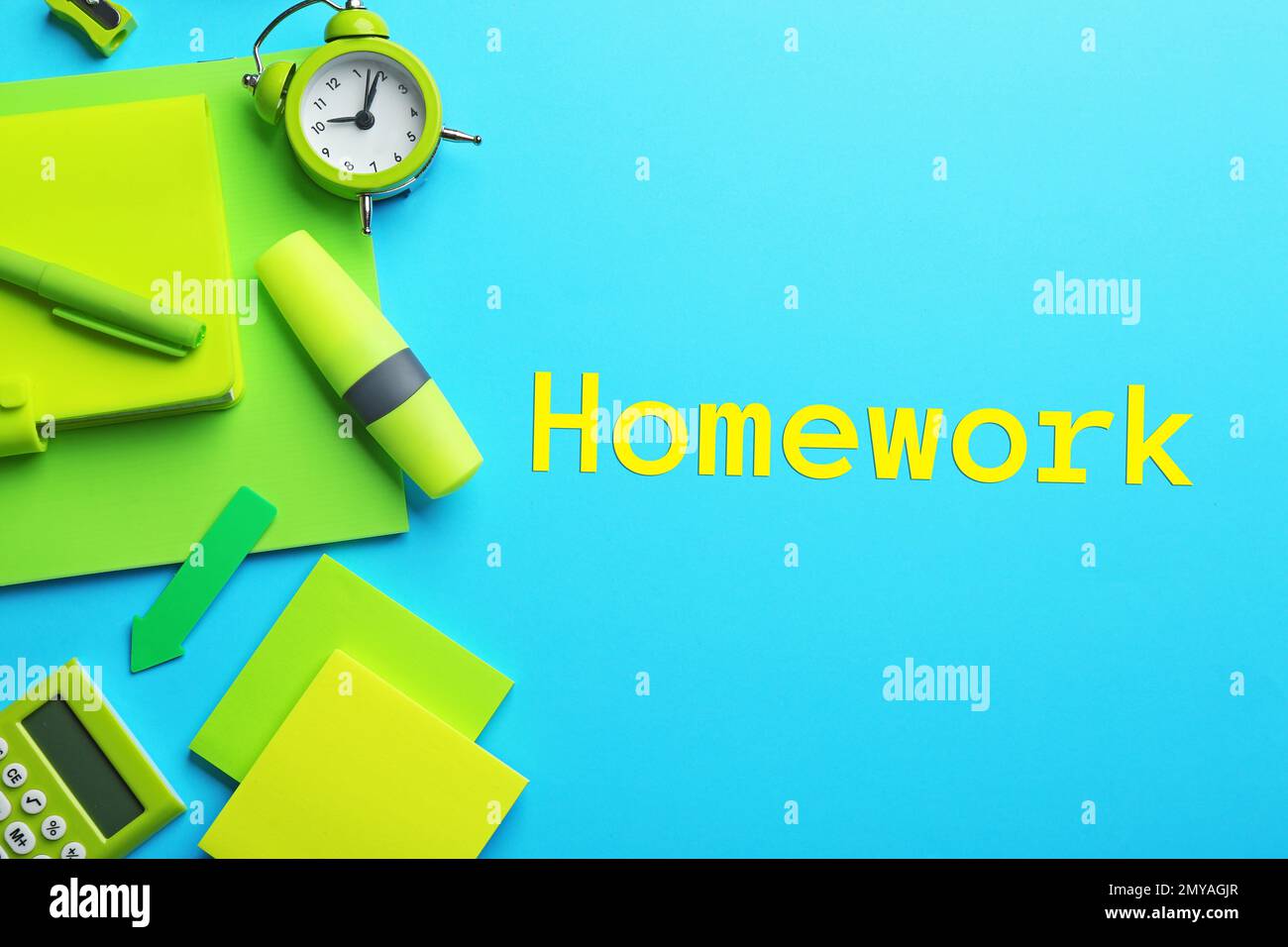 Green school stationery and inscription HOMEWORK on light blue ...
