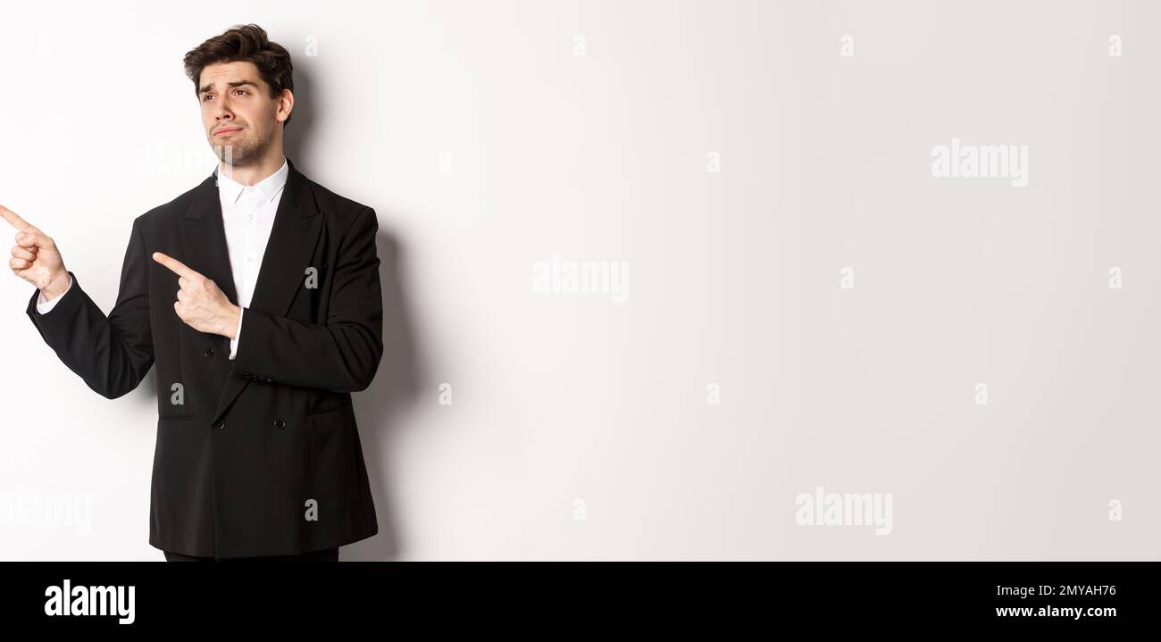 Image of upset and disappointed handsome guy in formal suit, pointing ...