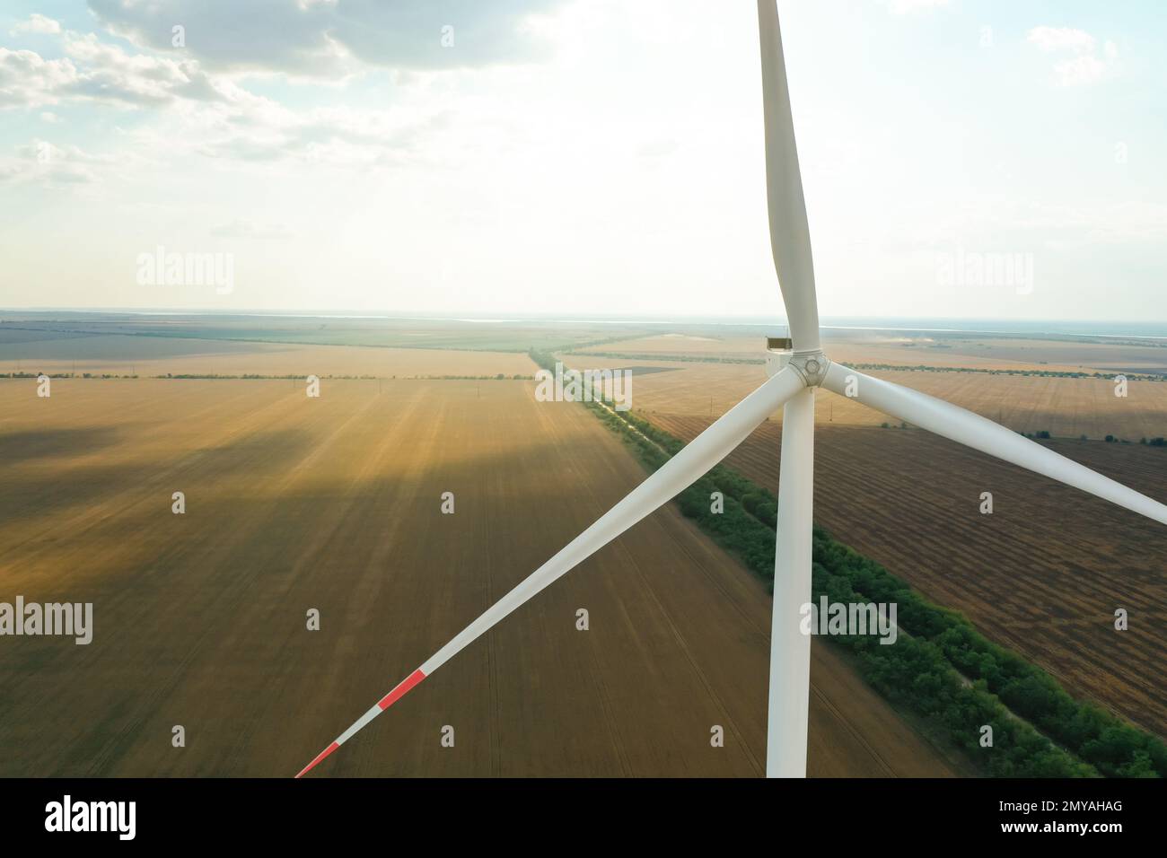 Modern windmill in field, space for text. Energy efficiency Stock Photo ...