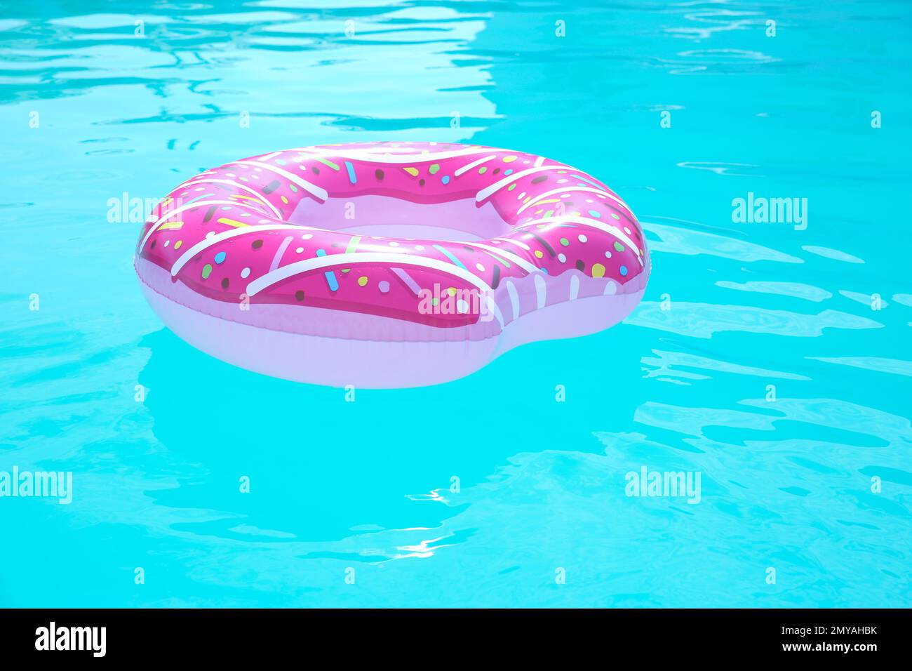 Inflatable ring in swimming pool on sunny day Stock Photo - Alamy