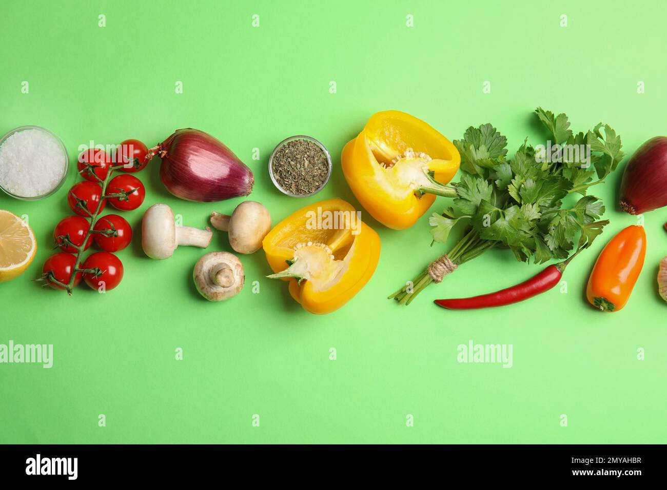 Flat lay composition with ingredients for cooking on green background ...