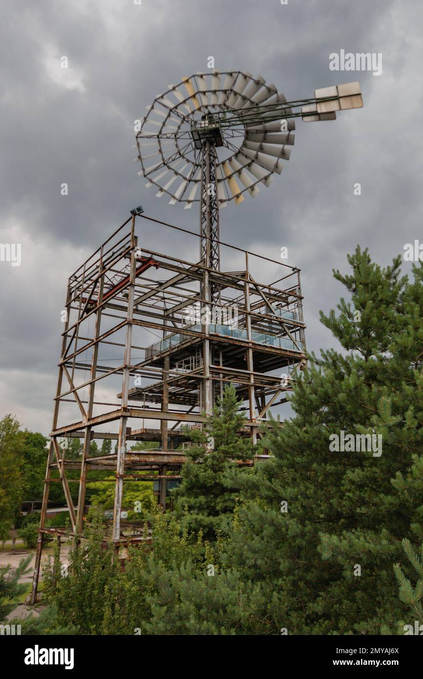 a steel tower with a large windmill, used to serve as a water pump. In ...