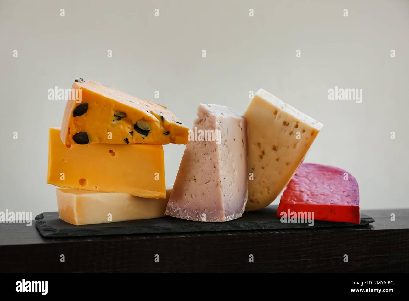Different types of delicious cheeses on slate plate, closeup Stock ...