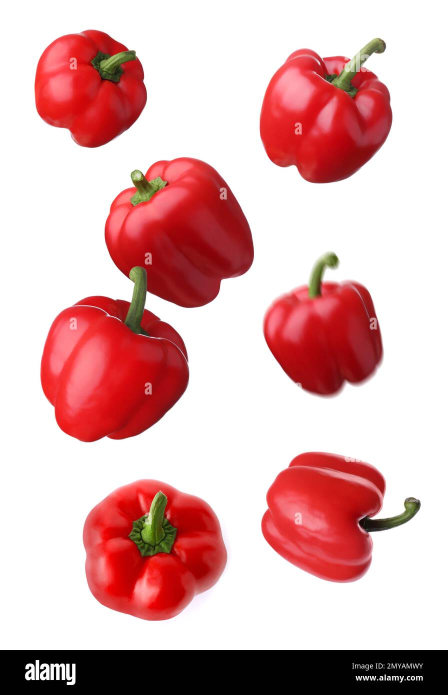 Red bell peppers falling on white background Stock Photo - Alamy