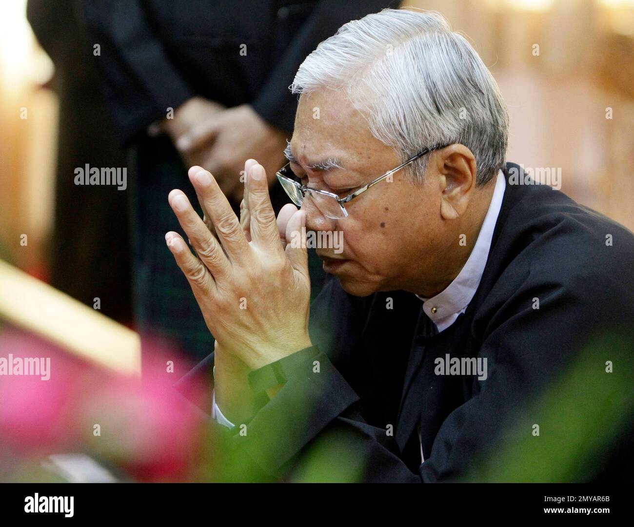 Myanmar President Htin Kyaw prays in front of a Buddha statue during an ...