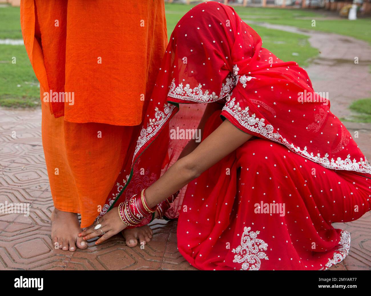 An Indian Hindu women touches the feet of a Hindu guru to express ...