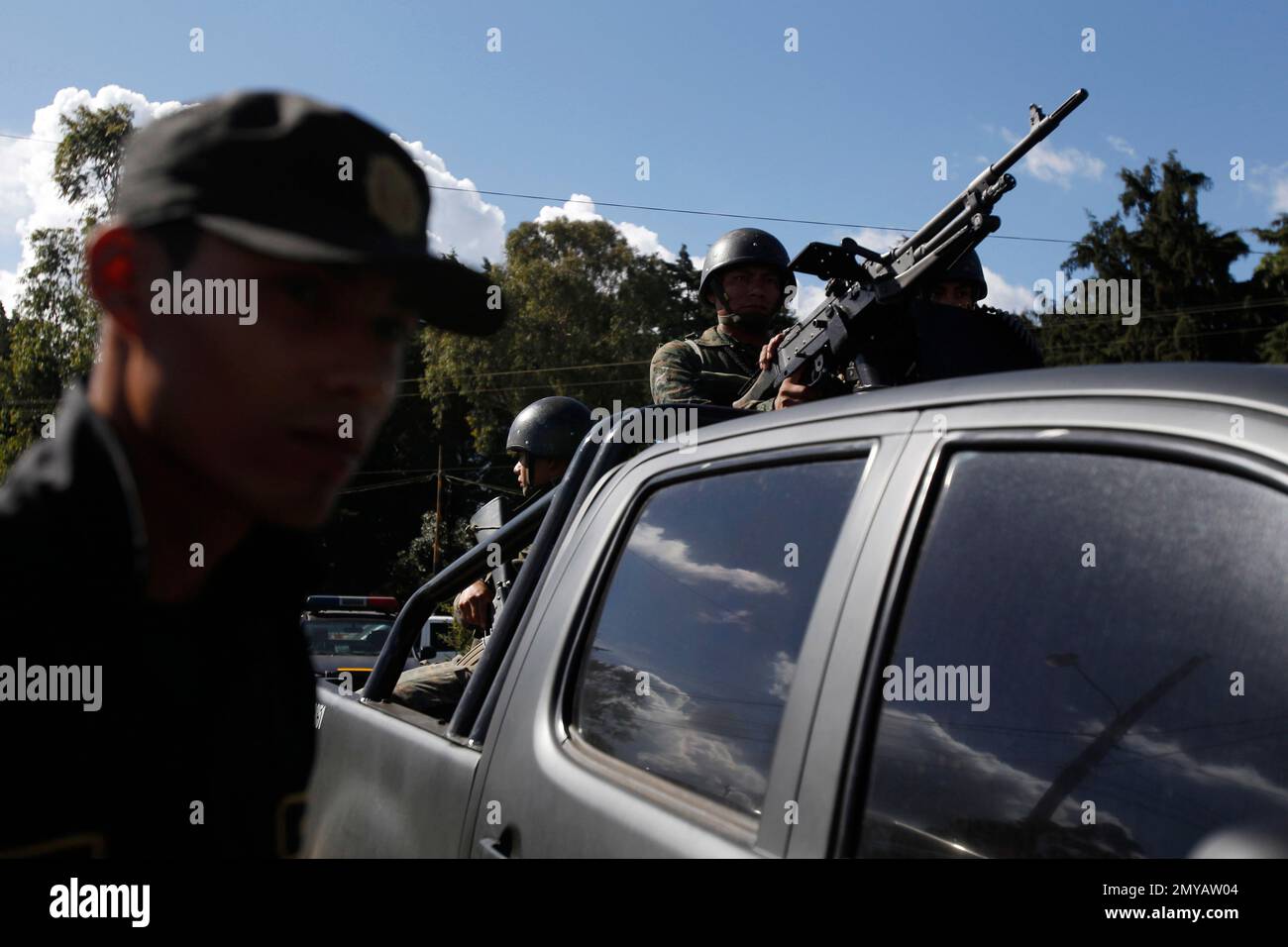 Soldiers stand guard inside a vehicle parked outside of the Pavon ...