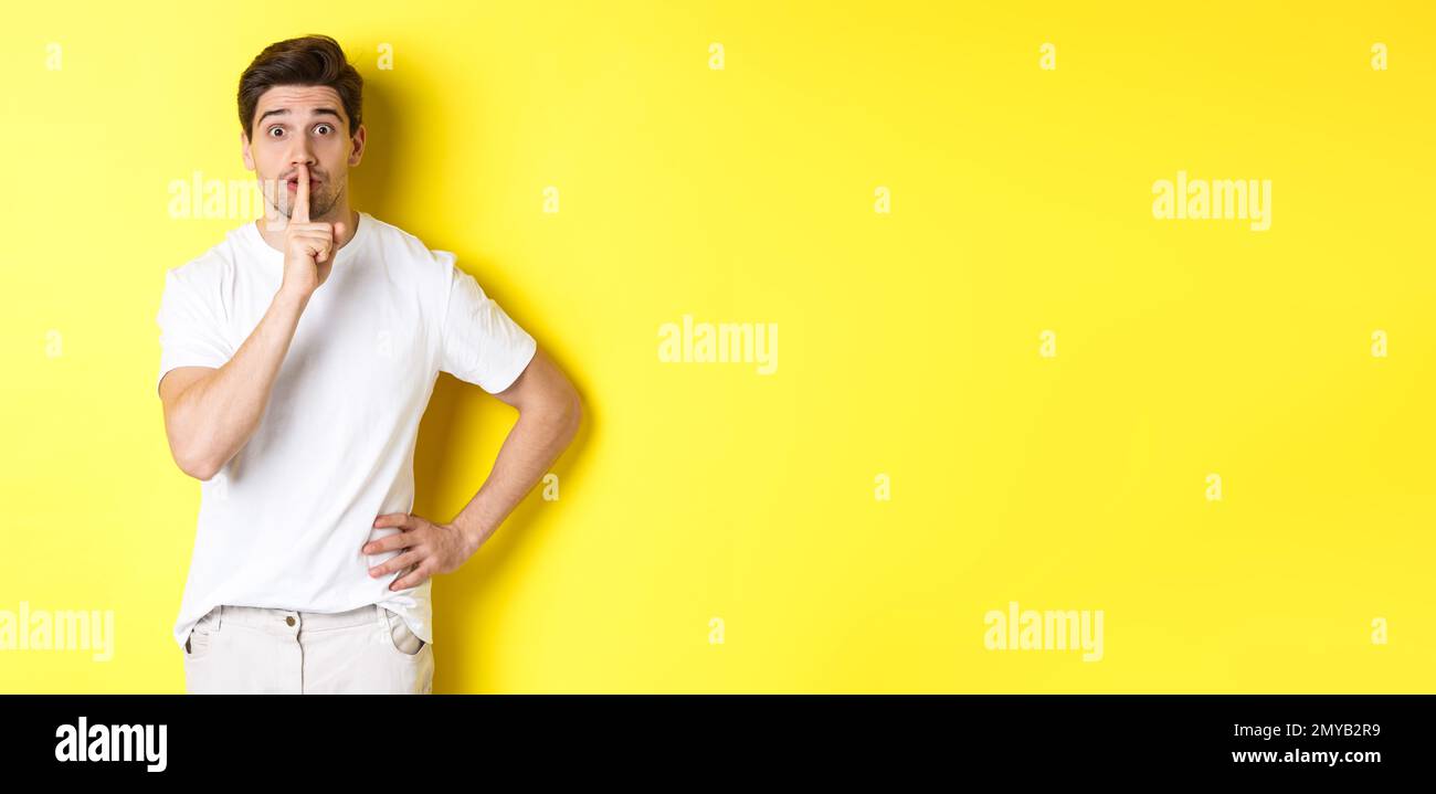 Image of excited guy planning surprise, shushing at camera, press ...