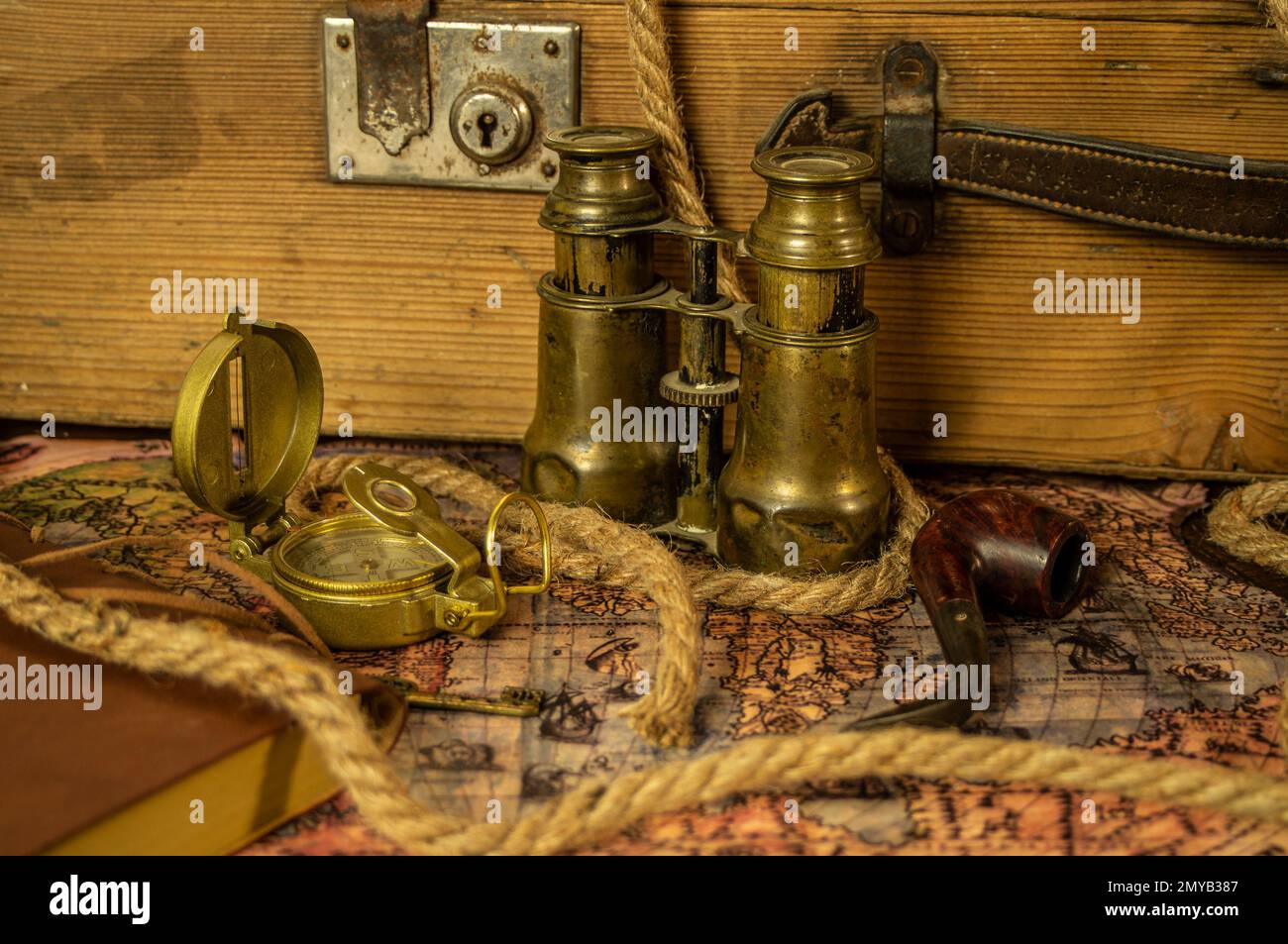 Antique adventure scroll background on adventurer table. Binoculars ...