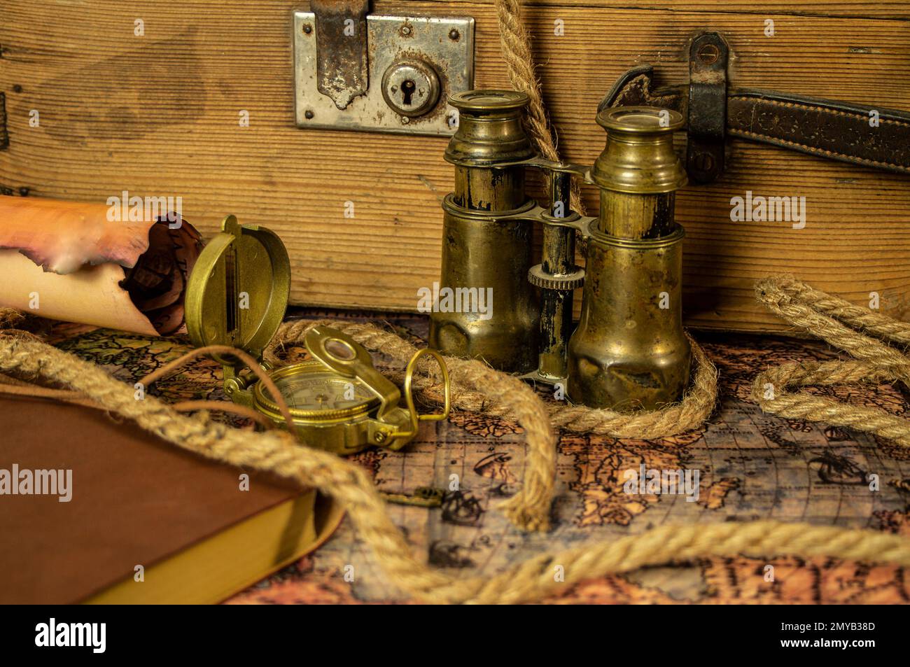 Antique adventure scroll background on adventurer table. Binoculars ...