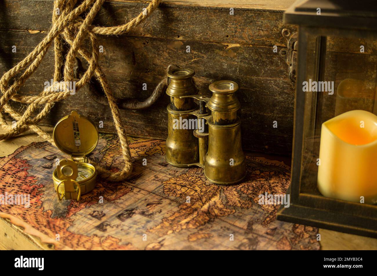 Antique adventure scroll background on adventurer table. Binoculars ...