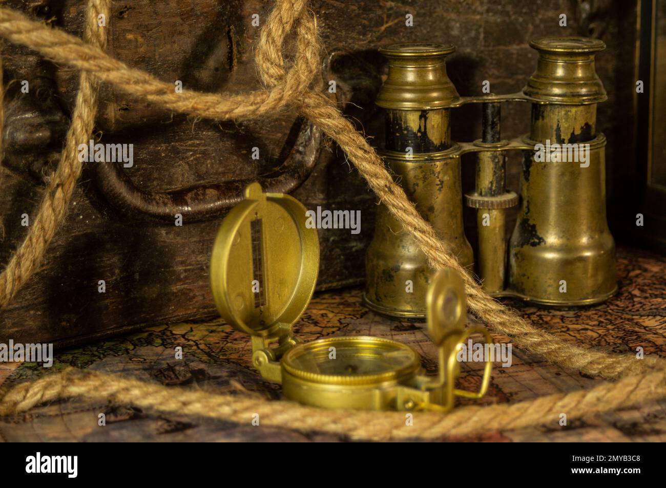 Antique adventure scroll background on adventurer table. Binoculars ...