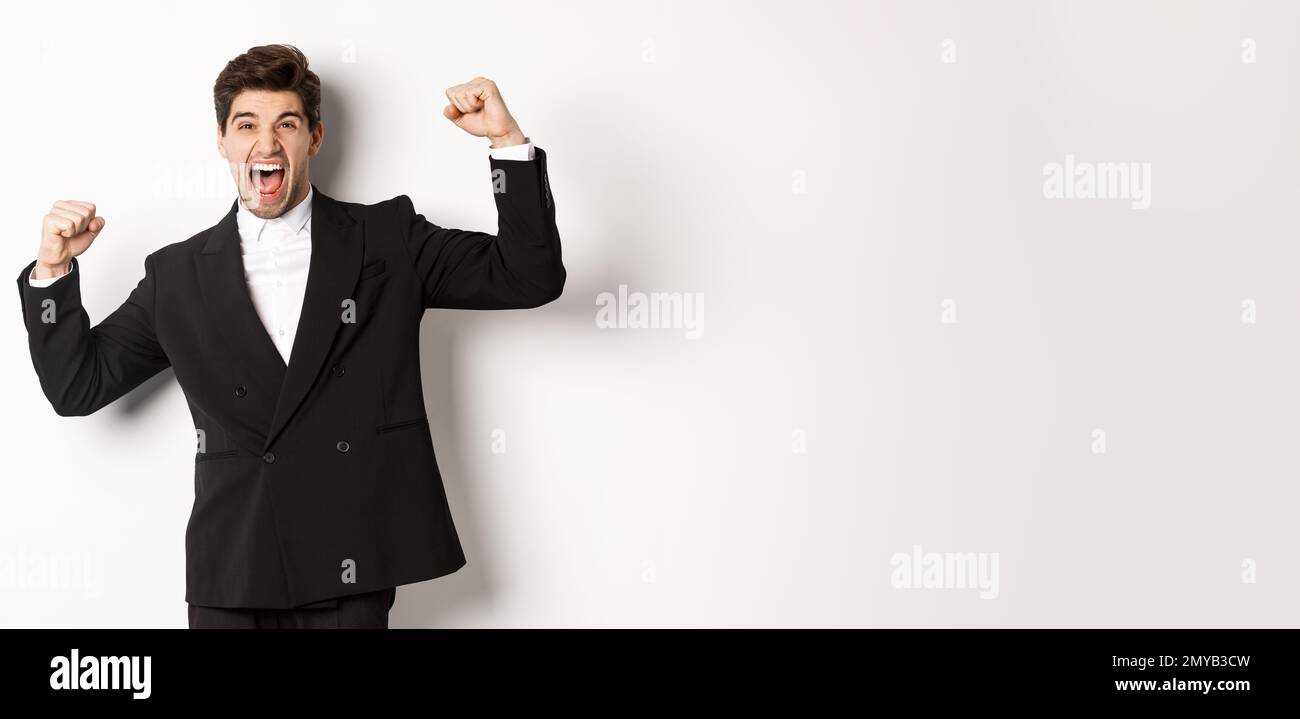 Portrait of successful businessman in black suit, become champion ...