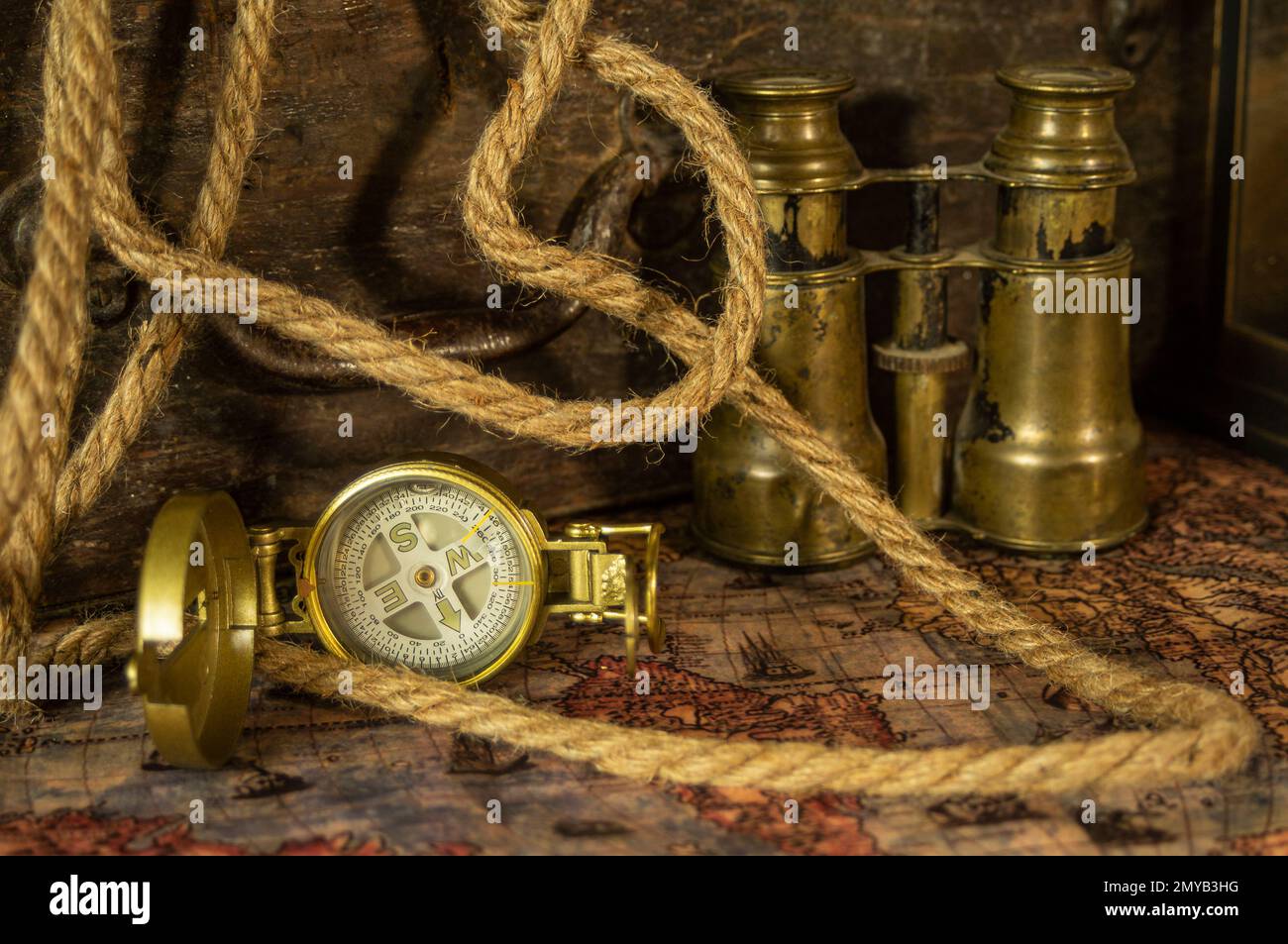 Antique adventure scroll background on adventurer table. Binoculars ...