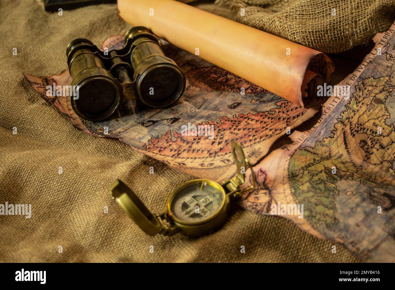 still life of adventure objects for exploration binoculars, compass ...