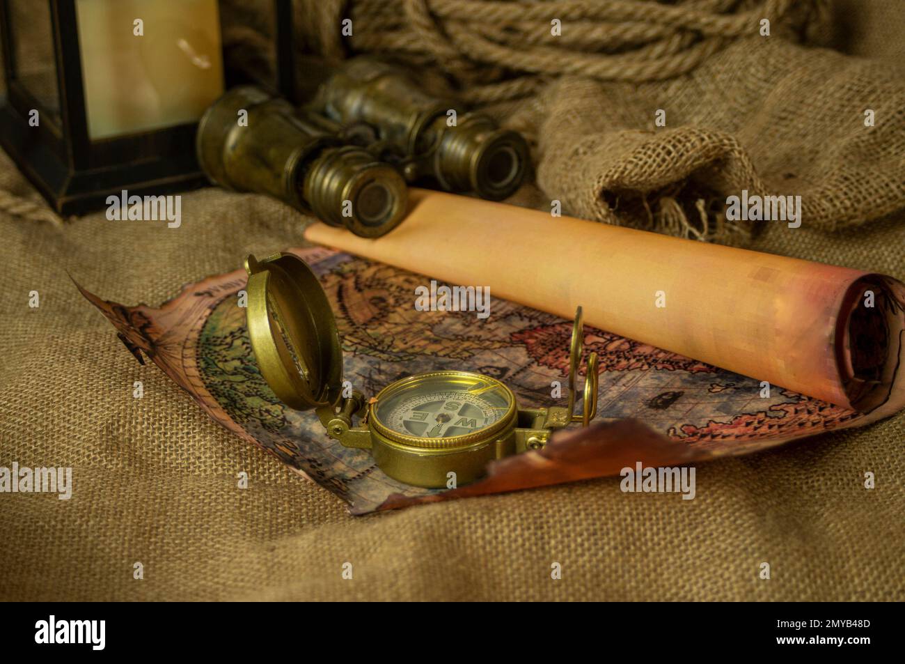 still life of adventure objects for exploration binoculars, compass ...