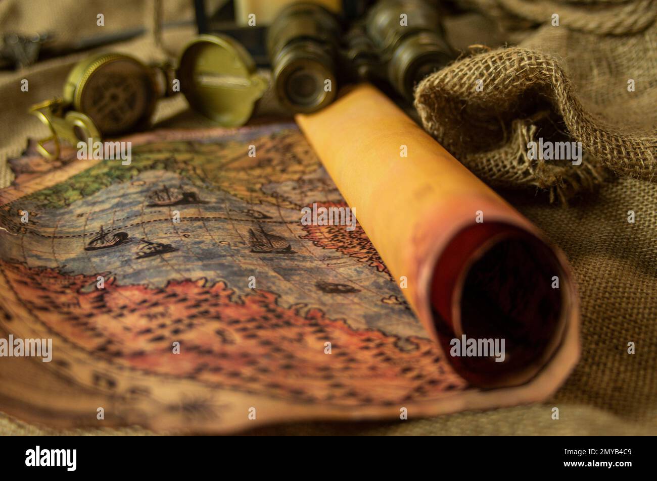 Still life of adventure objects for exploration binoculars, compass ...